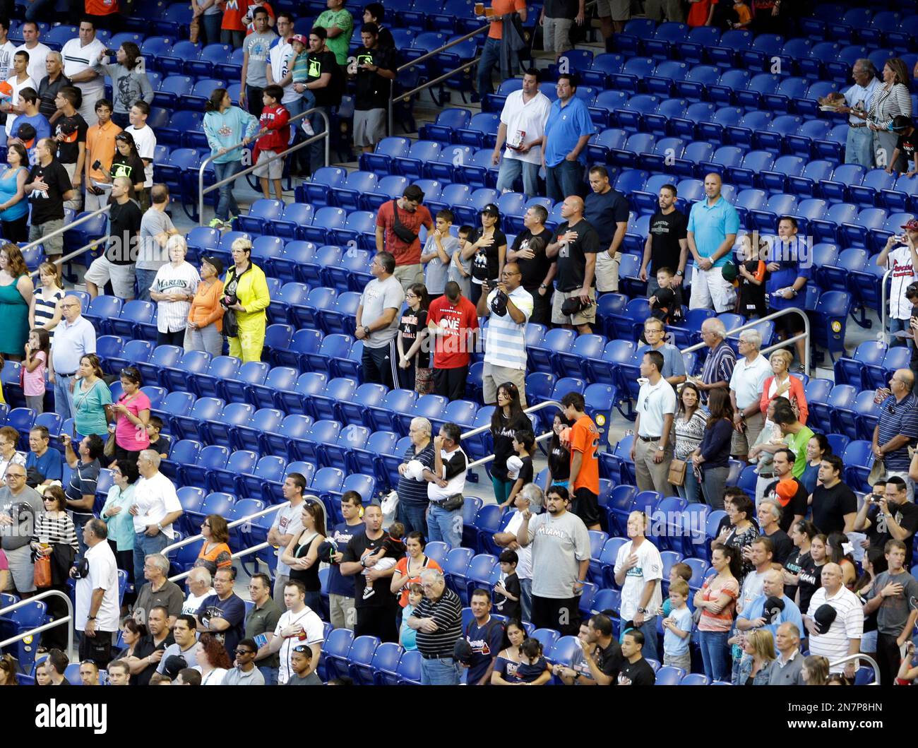 Fans stand during the singing of the National Anthem before the start ...