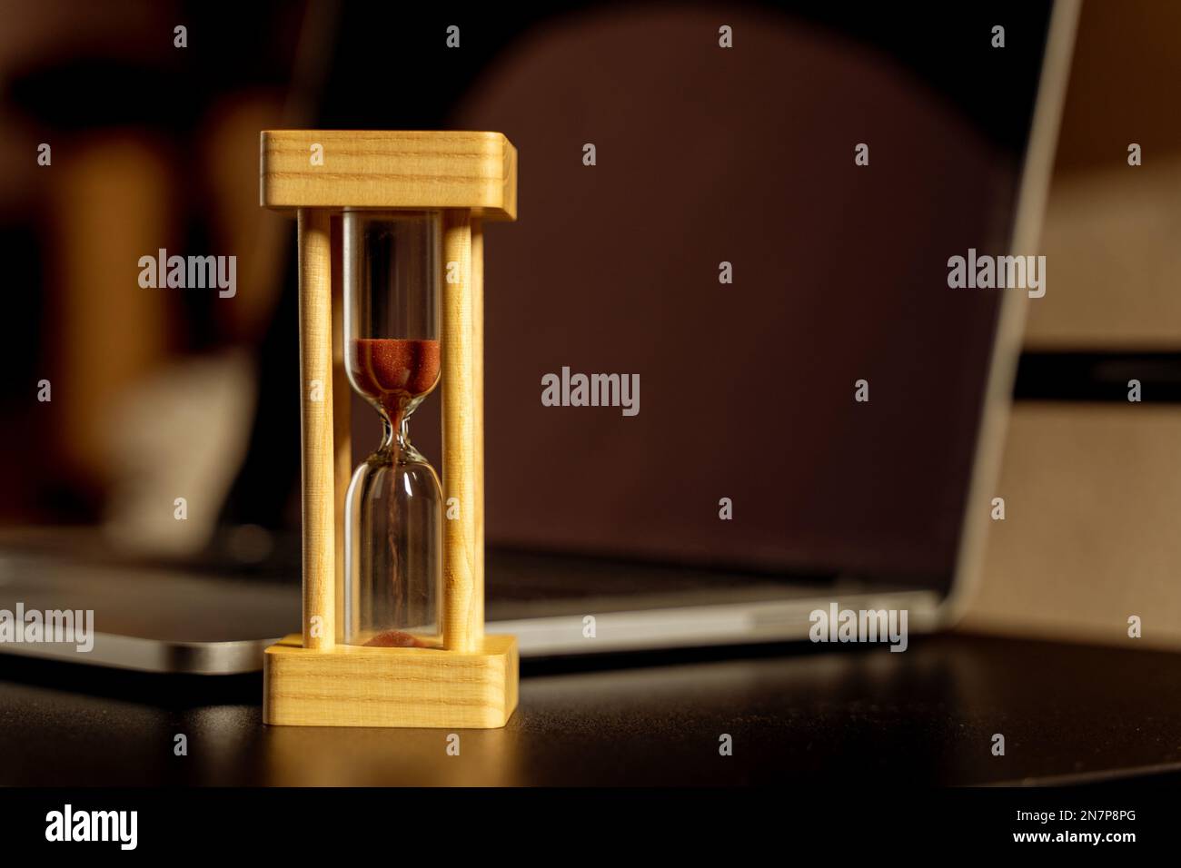 Laptop and hourglass on the desktop. Time management concept Stock ...