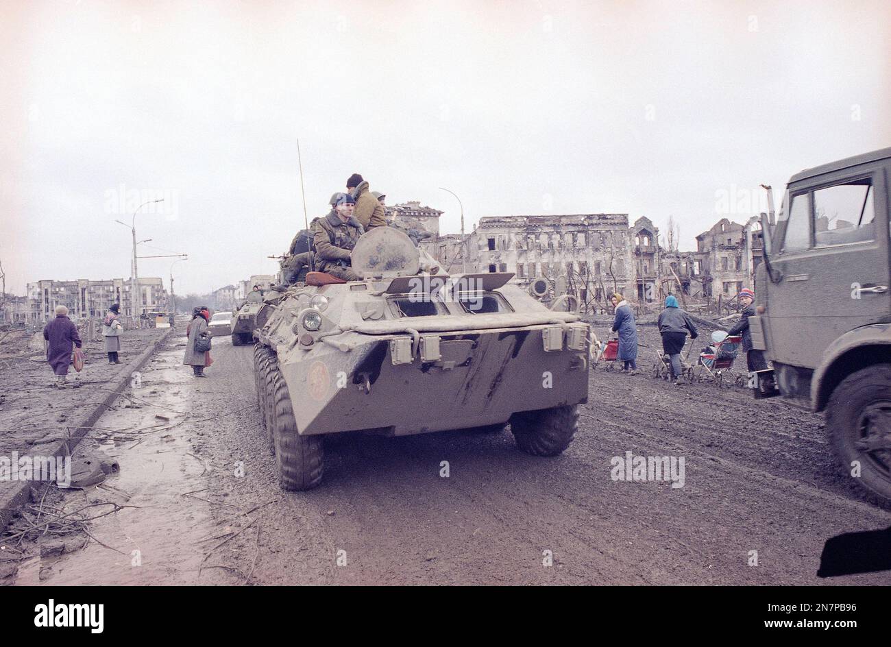 A Russian armored column passes through the devastated Chechen capital ...