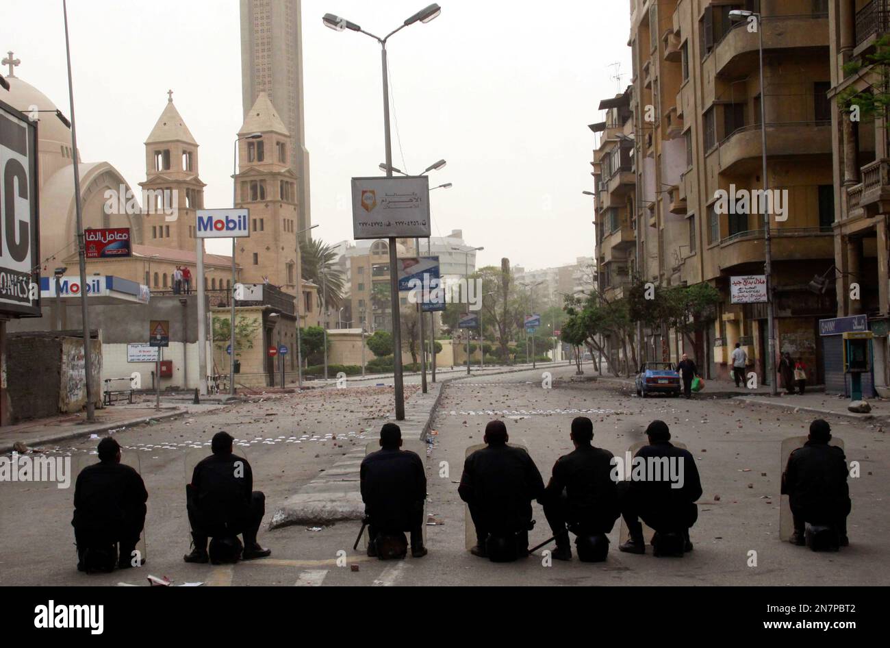 Egyptian riot police watch over the Coptic cathedral in the early hours ...