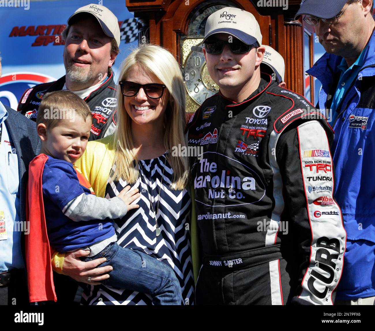 Johnny Sauter holds his son, Penn, as his wife, Cortney, left, joins ...