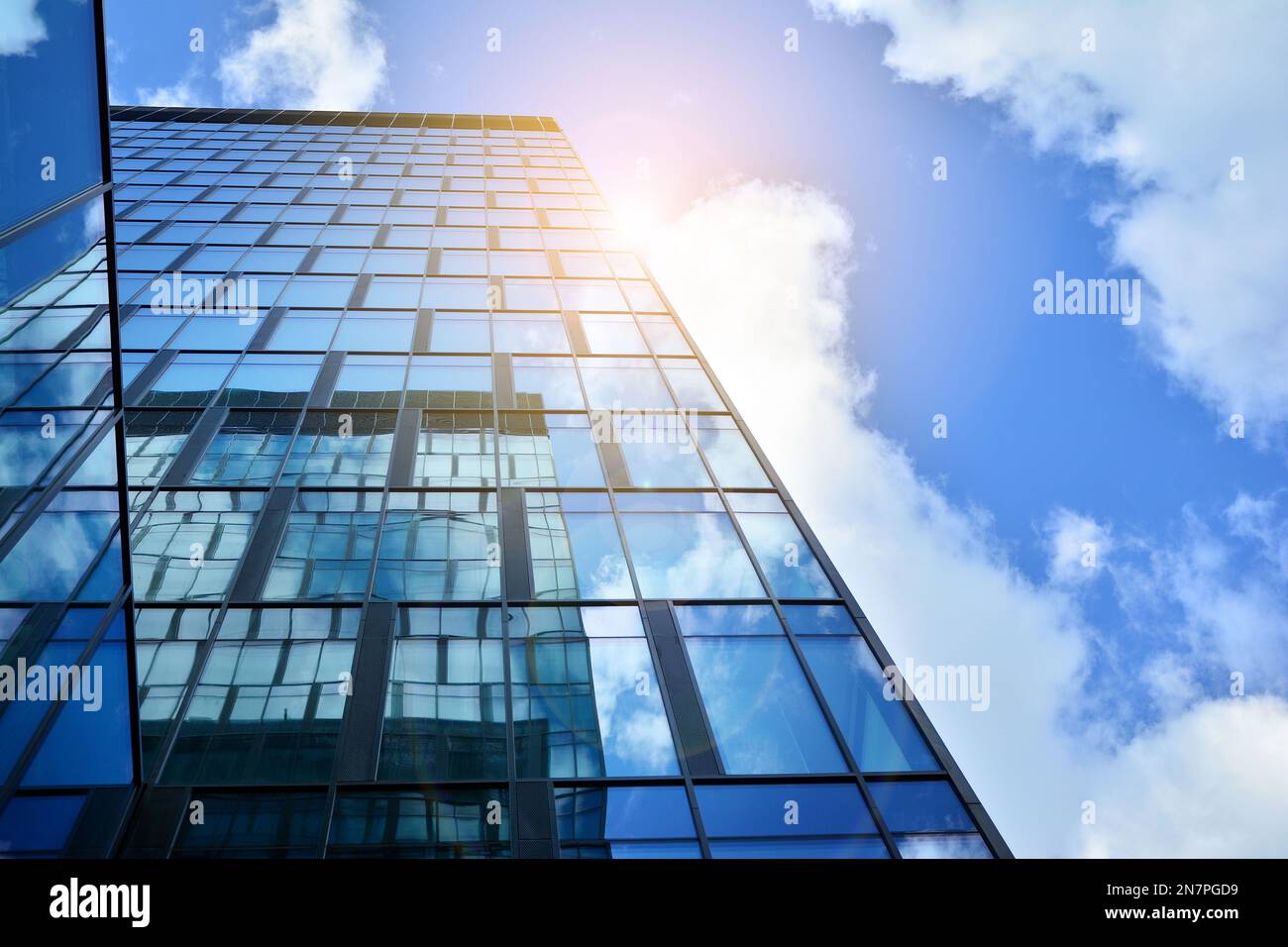 Bottom view of modern skyscrapers in business district against blue sky ...