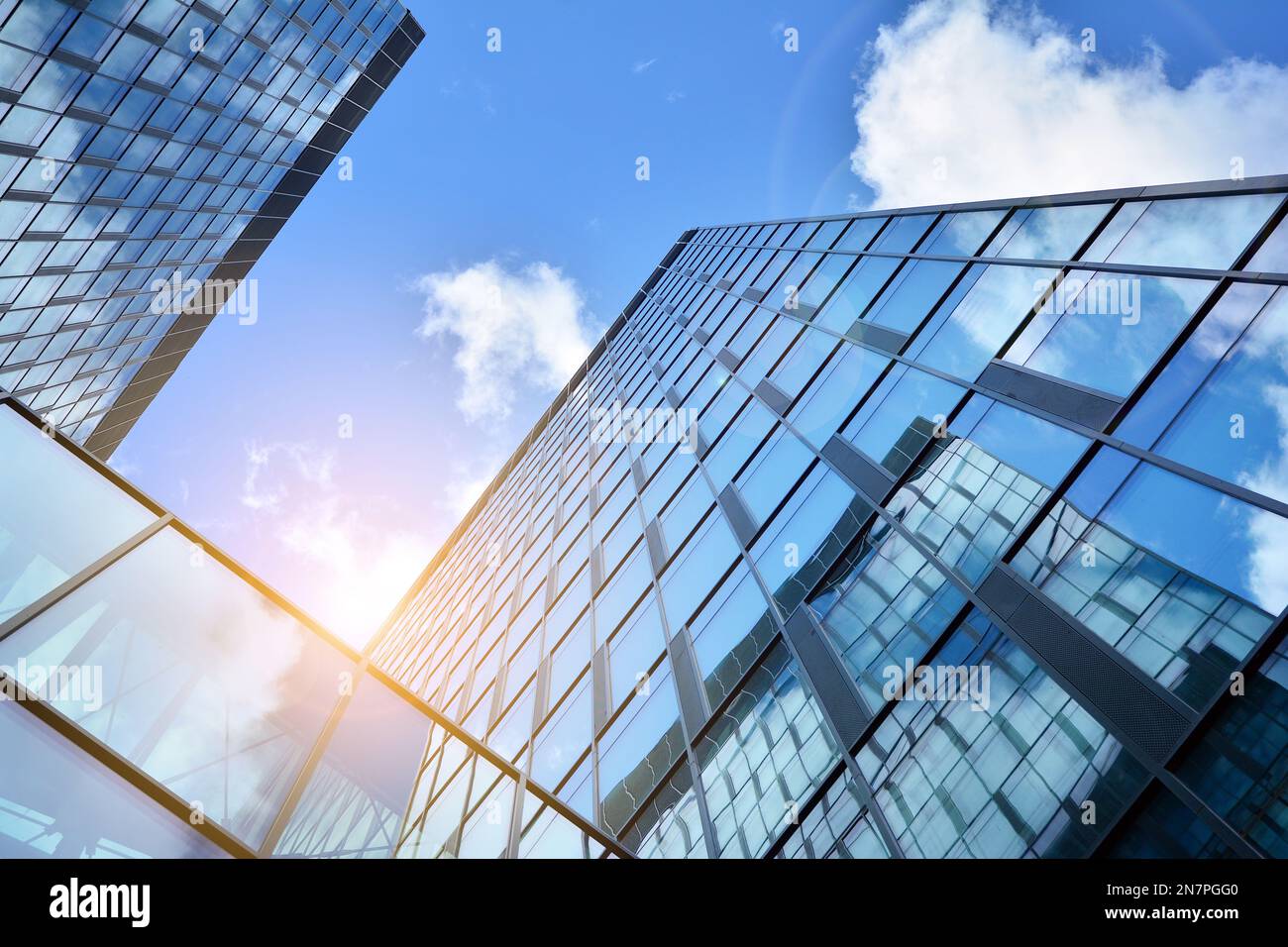 Bottom view of modern skyscrapers in business district against blue sky ...