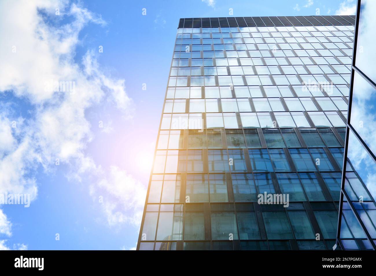 Bottom view of modern skyscrapers in business district against blue sky ...
