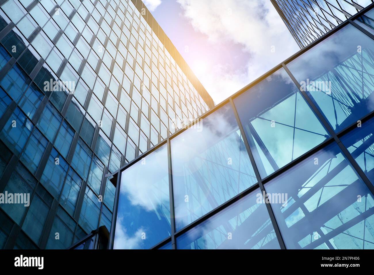 Bottom view of modern skyscrapers in business district against blue sky ...