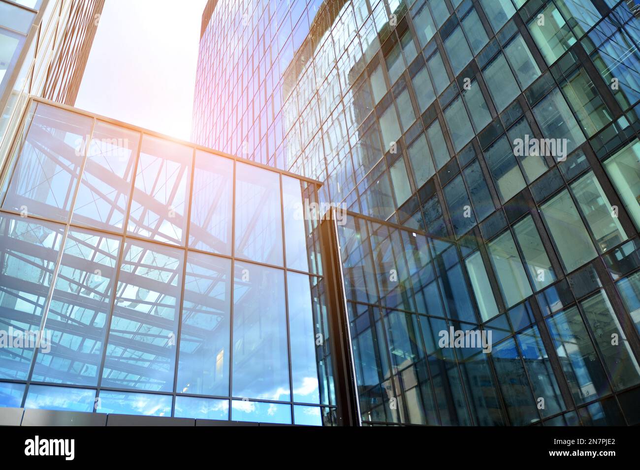 Bottom view of modern skyscrapers in business district against blue sky ...