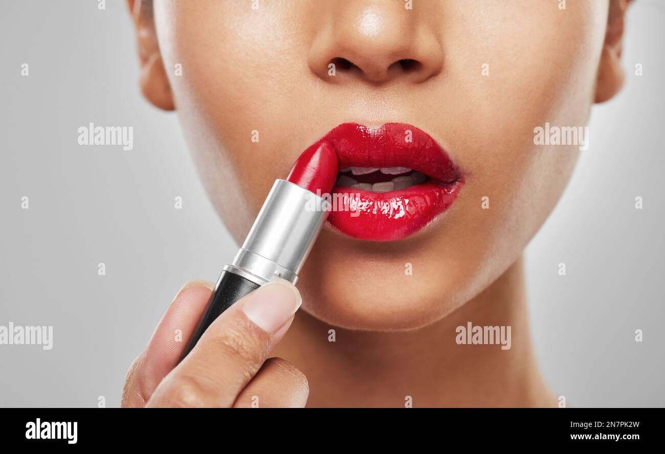 Lifes better in red lipstick. Studio shot of an unrecognisable woman ...