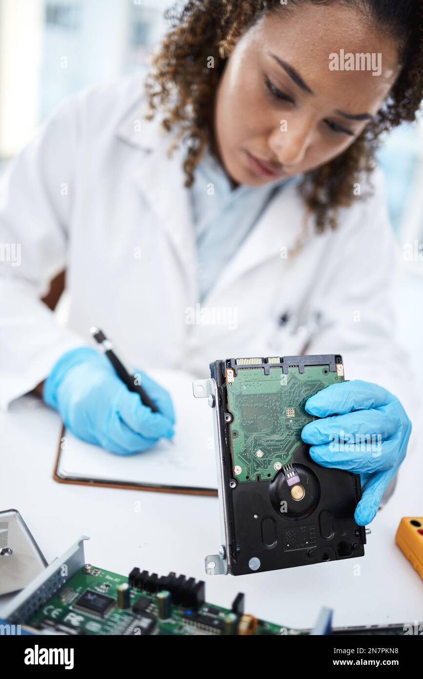 Black woman technician, computer or laptop motherboard for cyber crime ...