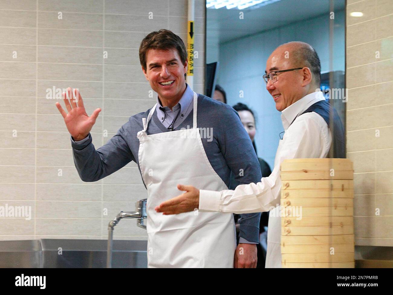 Waving to media, actor Tom Cruise arrives to make dumplings at the ...