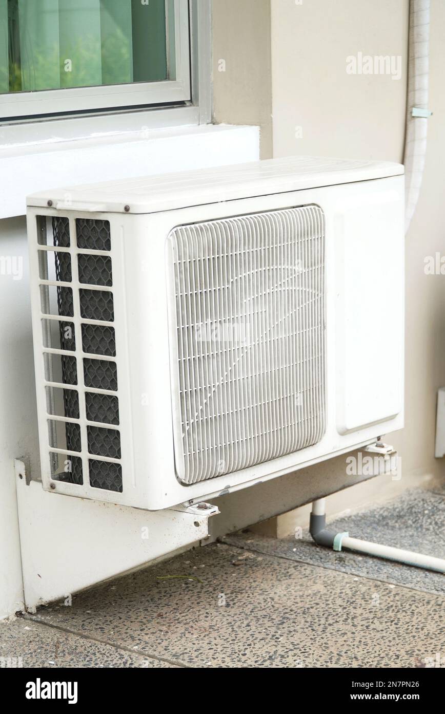 outdoor unit of split air conditioner for cooling, hanging on the wall ...