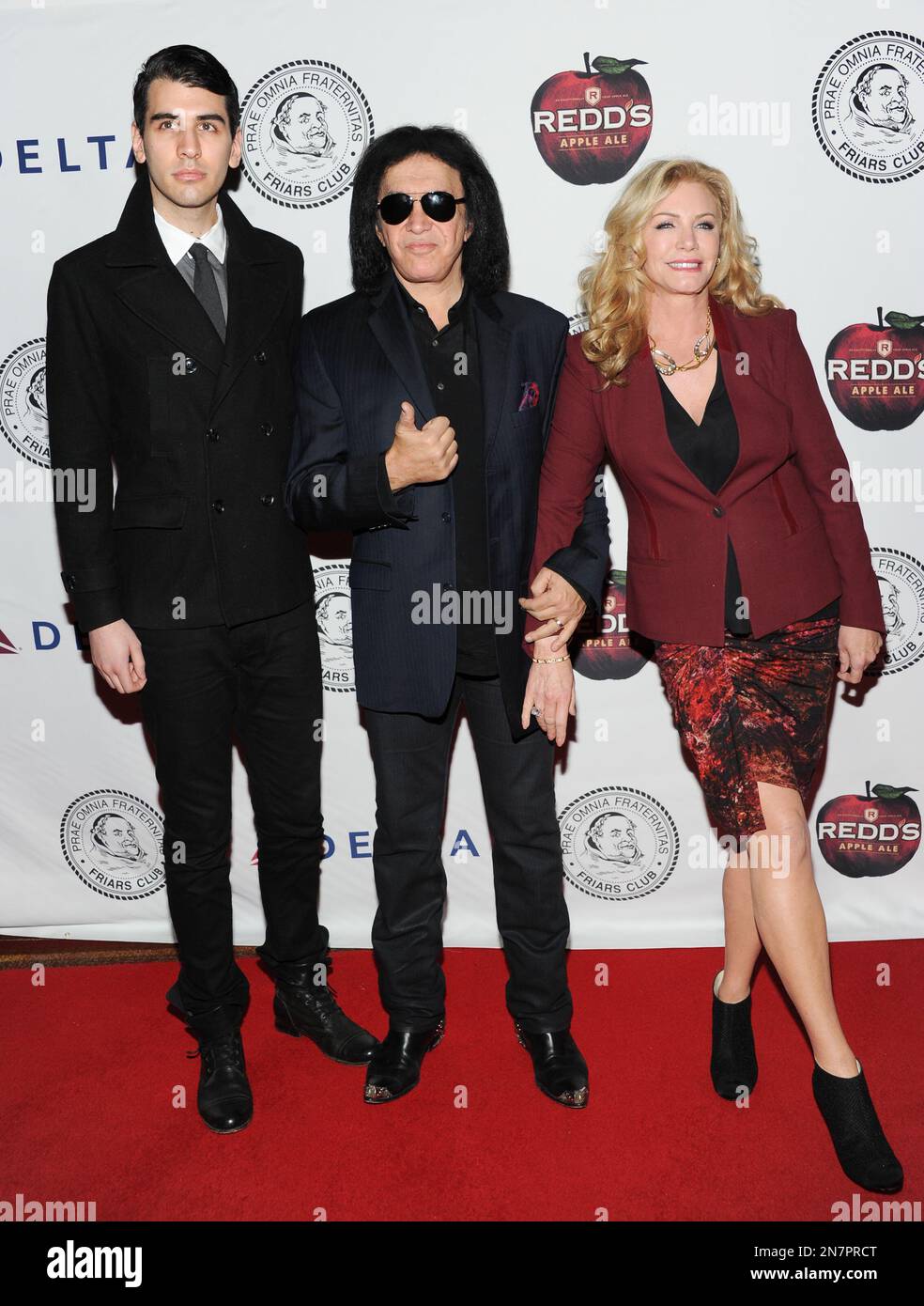 Musician Gene Simmons, center, poses with his son Nick and wife Shannon ...