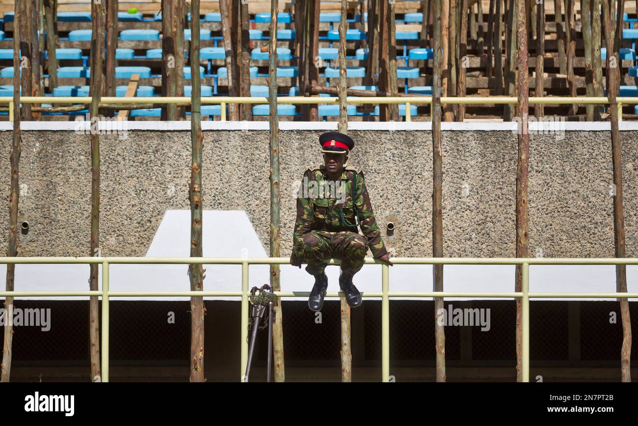 A member of the Kenyan military sits on wooden scaffolding being ...
