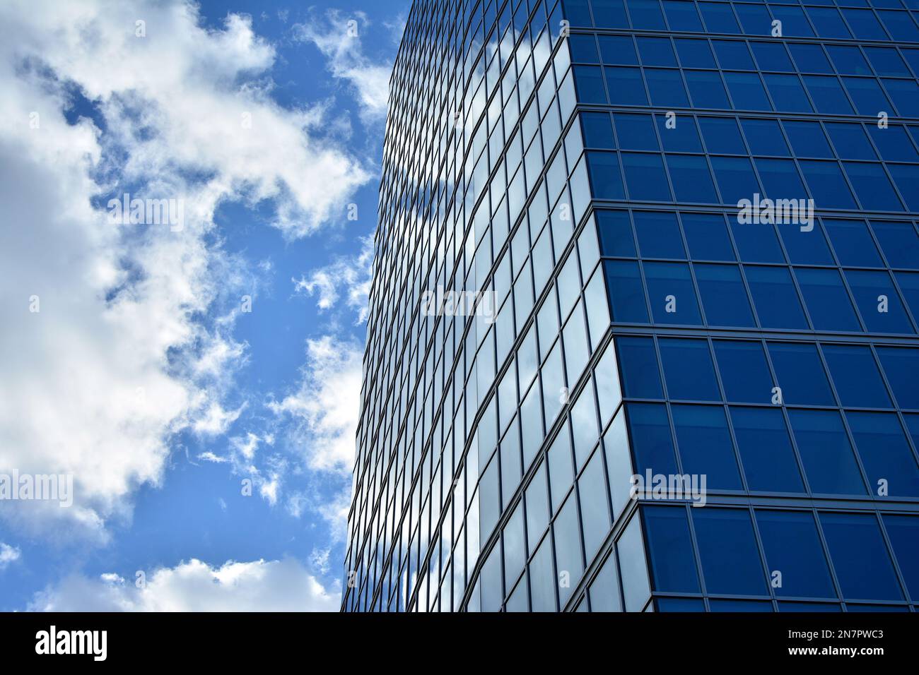 Bottom view of modern skyscrapers in business district against blue sky ...