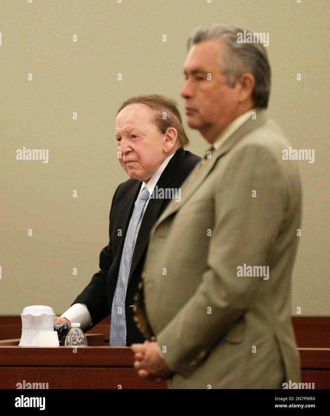 Las Vegas Sands Corp. CEO Sheldon Adelson, left, stands with his lawyer Stephen Peek, as the ...