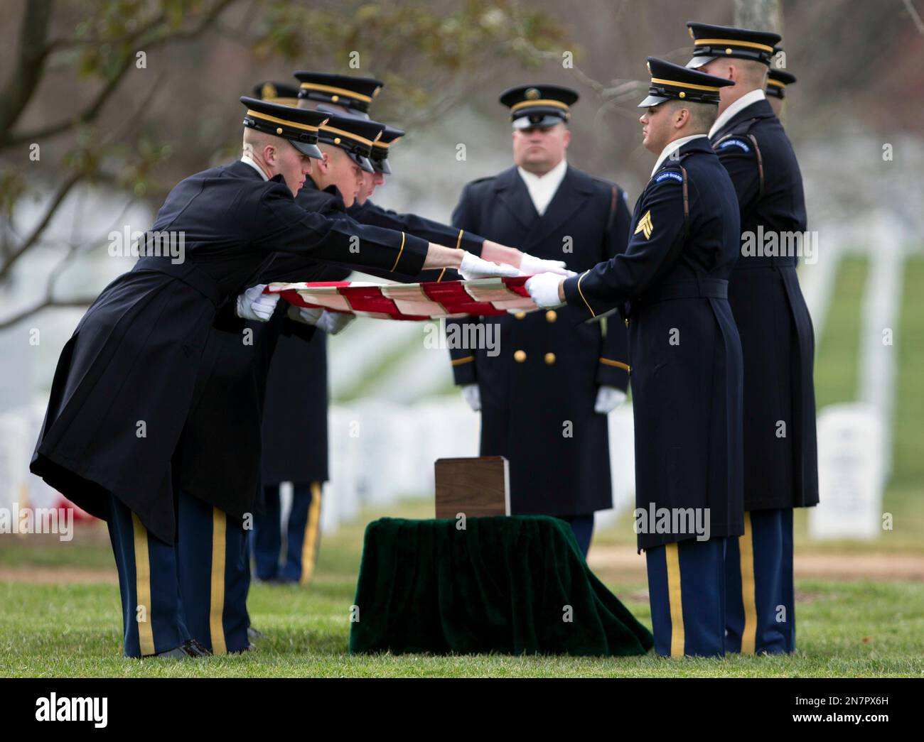 An Army honor guard fold the flag that draped the casket of Staff Sgt ...