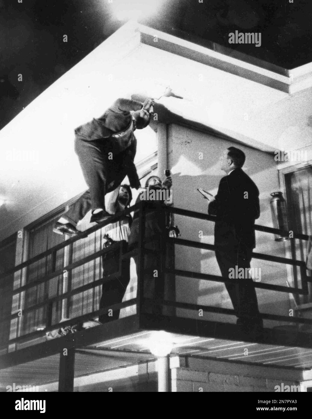 FILE - Memphis detectives climb on a rail outside the room of Dr ...