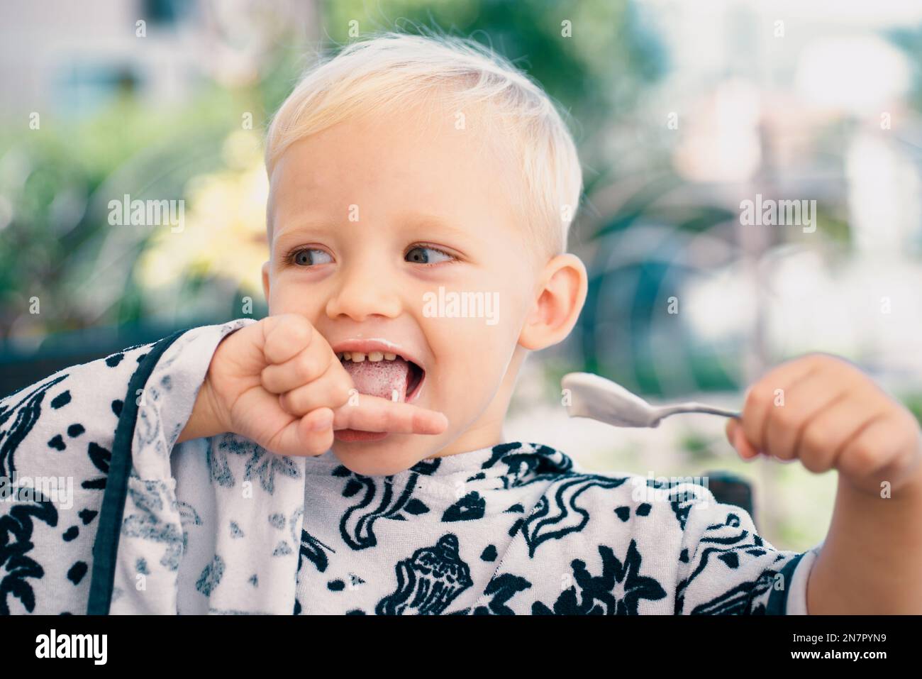 Baby eating with spoon. Kid food. Kids nutrition. Healthy food for ...