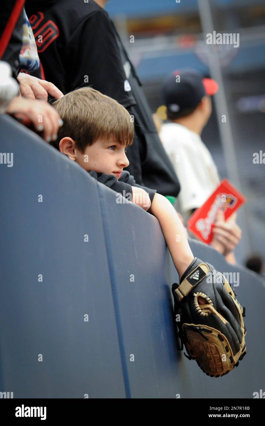 Atlanta Braves fan Elijah Ammons, 7, right, from Macon, Ga., waits for ...