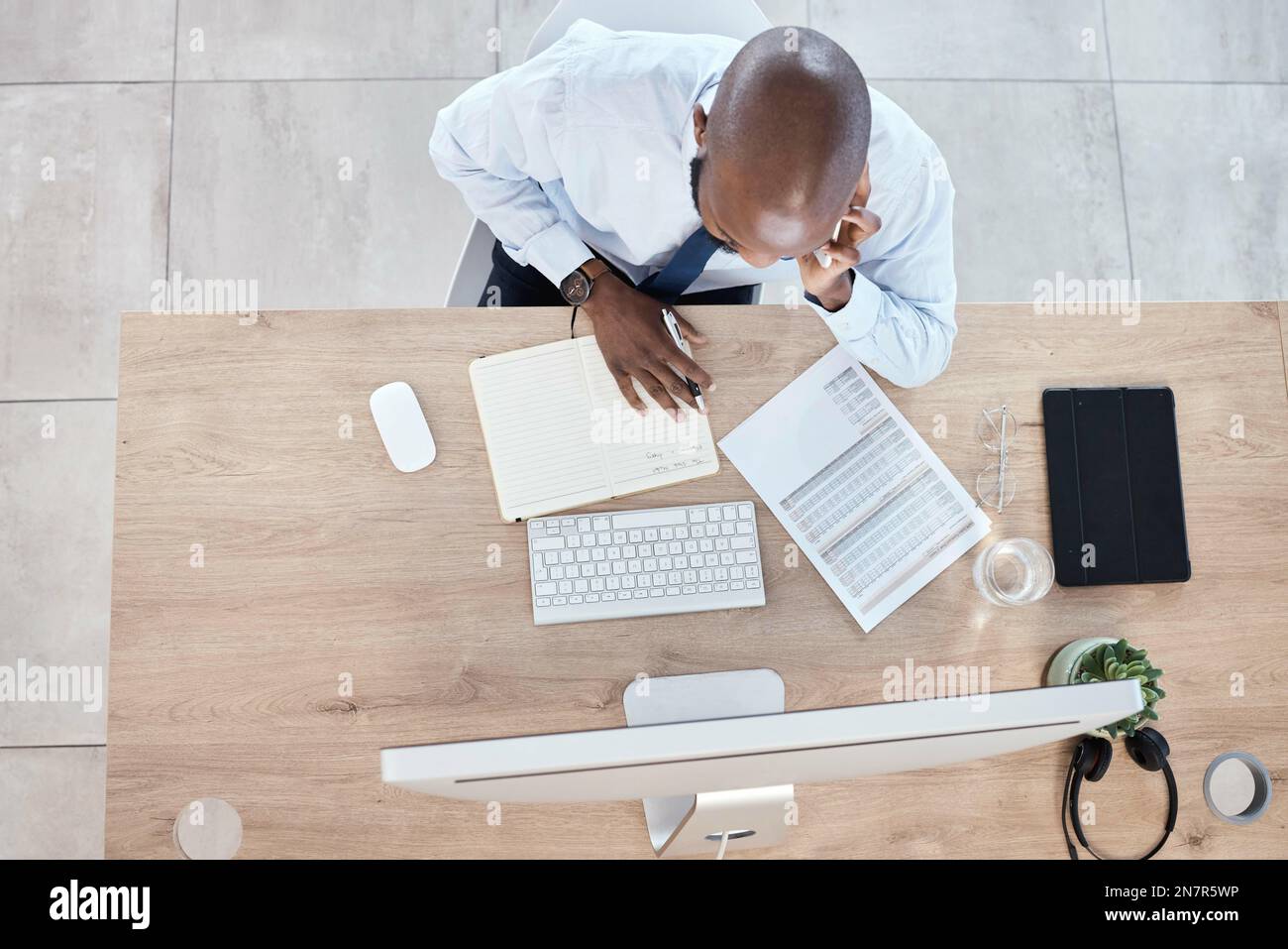 Documents, notes and businessman on phone call planning a schedule or ...