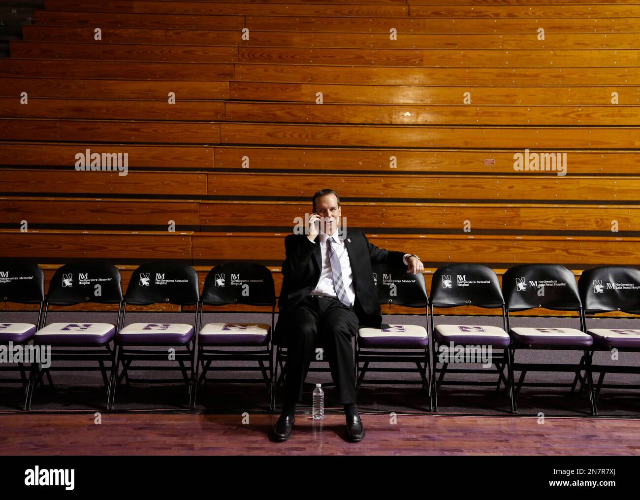 Chris Collins gives a radio interview on the bench after being named ...