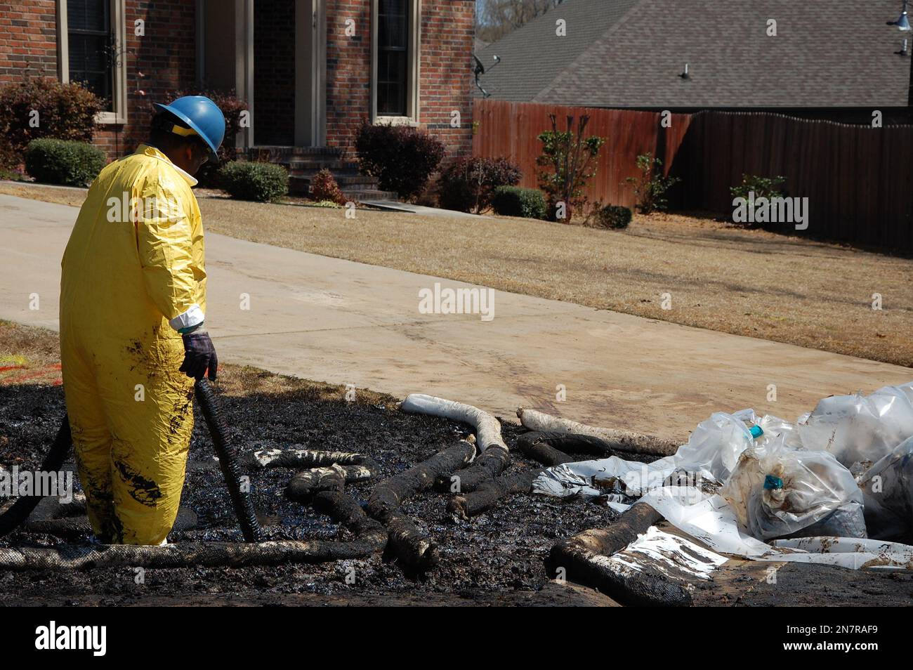 A worker cleans up oil in Mayflower, Ark., on Monday, April 1, 2013 ...