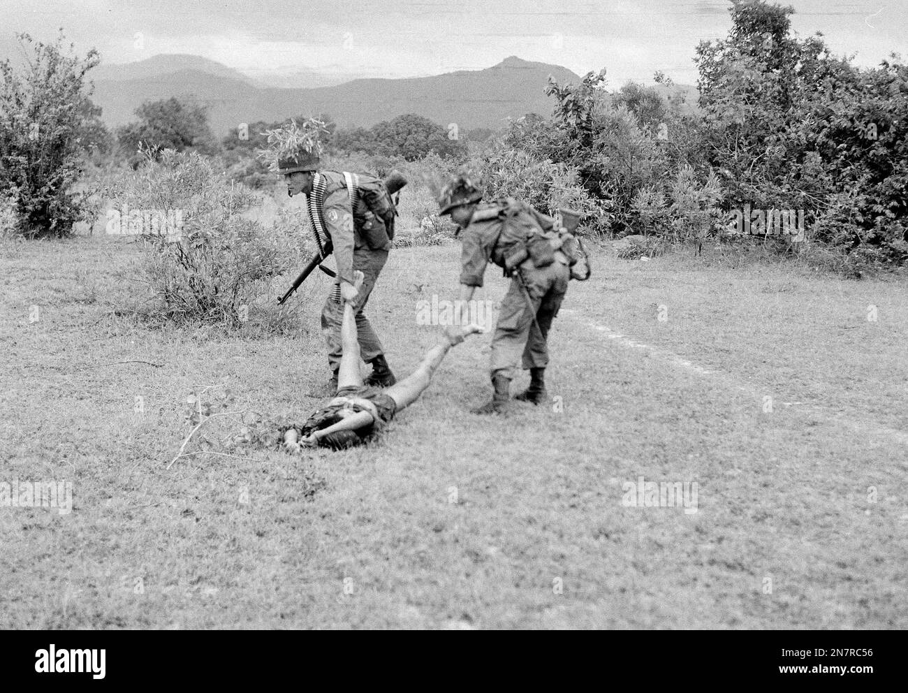 EDS NOTE: GRAPHIC CONTENT - Two Korean infantrymen drag a dead Viet ...