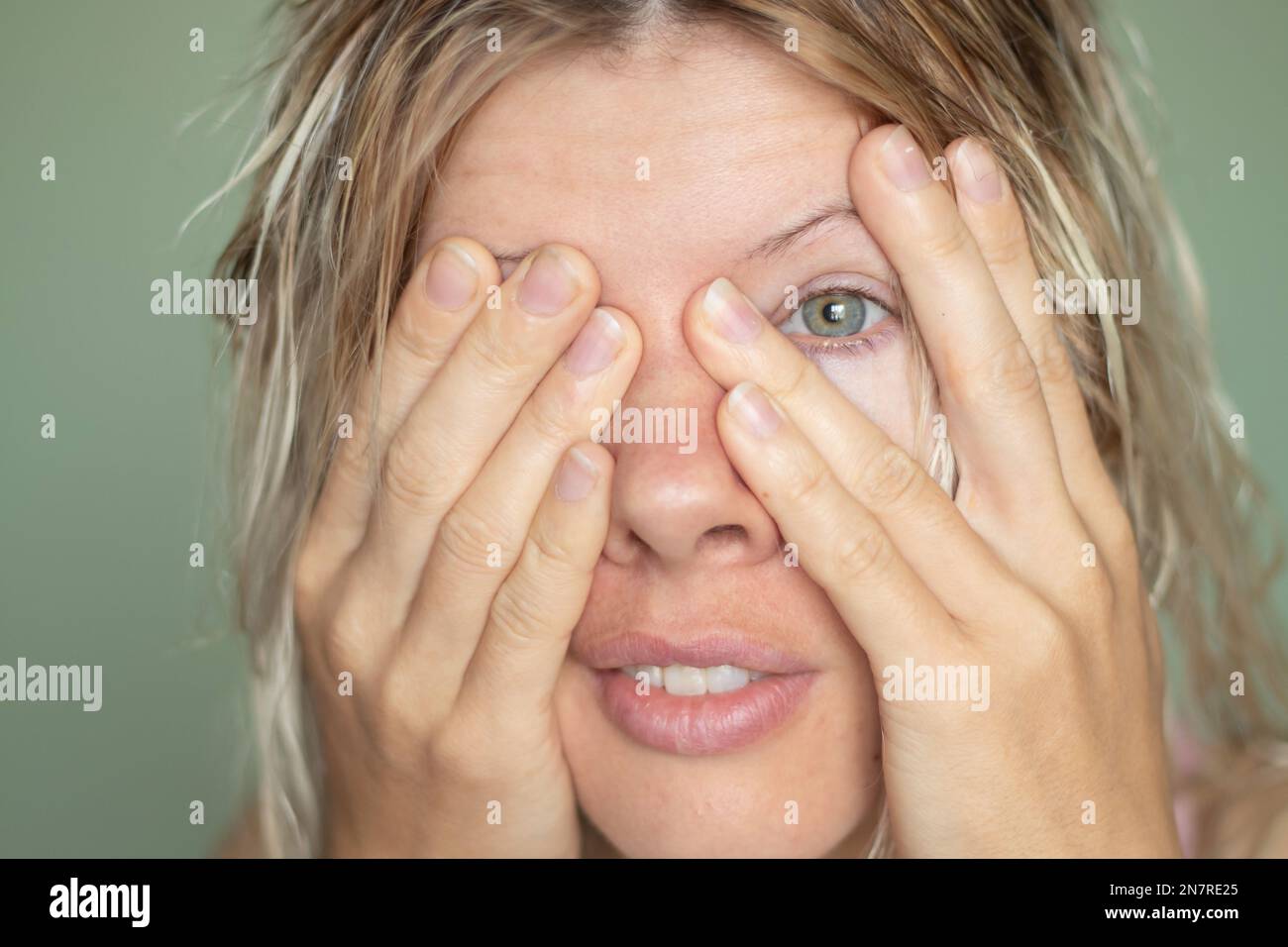 Young Girl Covered Her Face With Hands Closeup Portrait On An Isolated