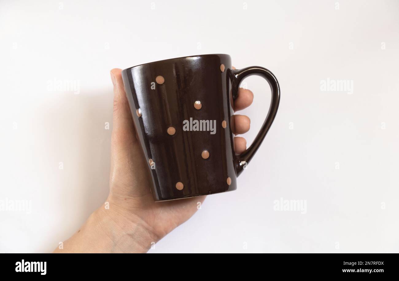 cup in woman's hand on an isolated background Stock Photo - Alamy