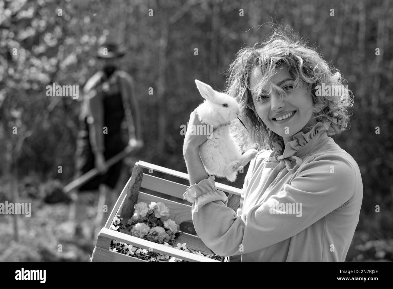 Closeup of winking girl with bunny rabbit. Portrait of young woman ...