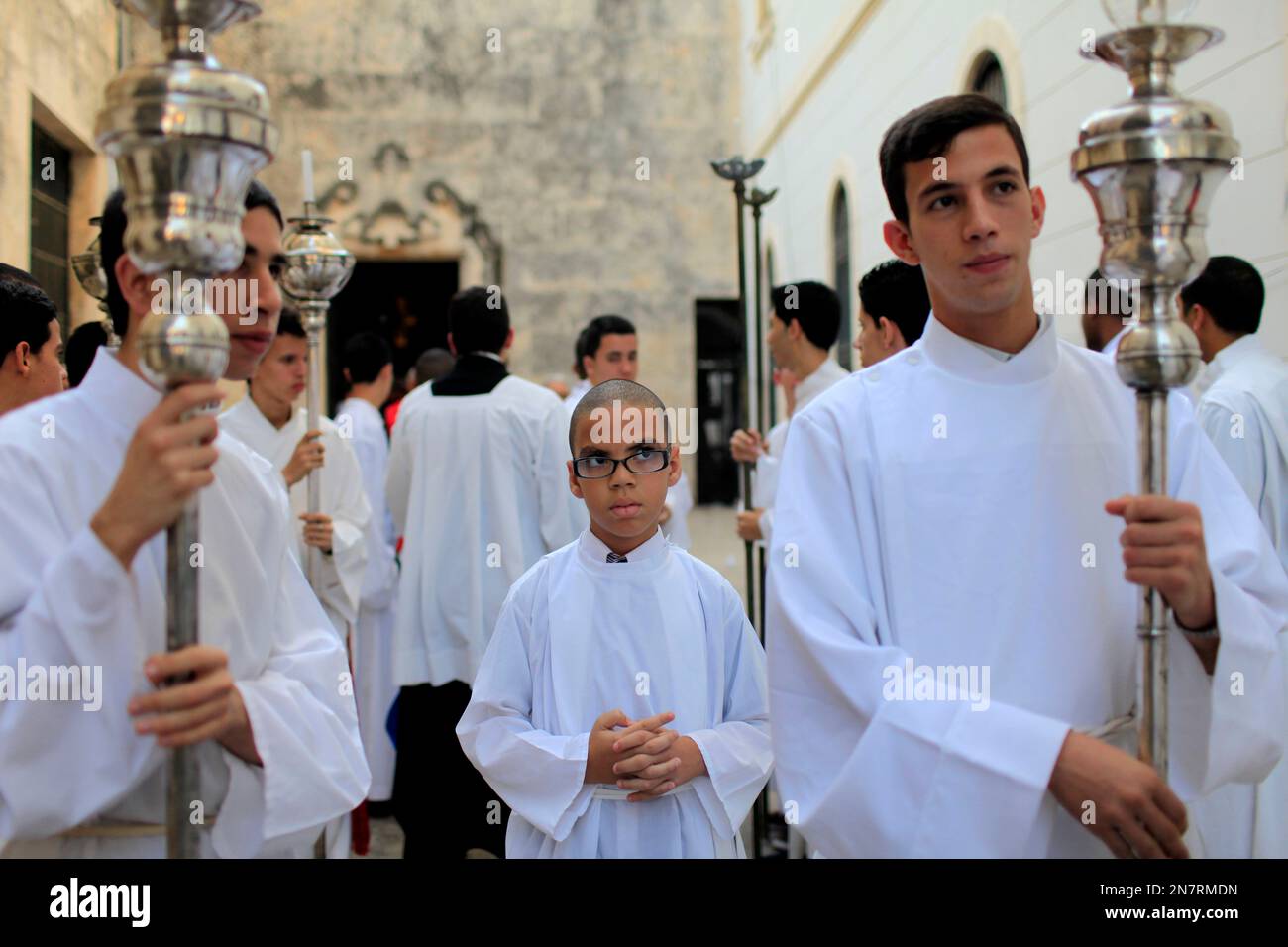 Altar boys wait for the start of a Good Friday procession in Havana ...