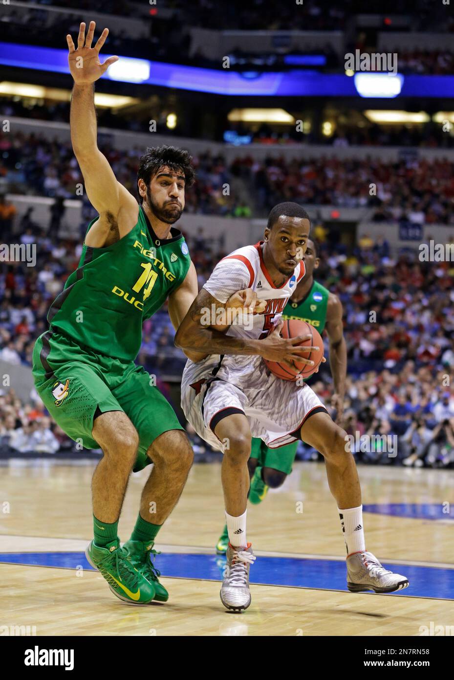 Louisville guard Kevin Ware (5) drives against Oregon forward Arsalan ...