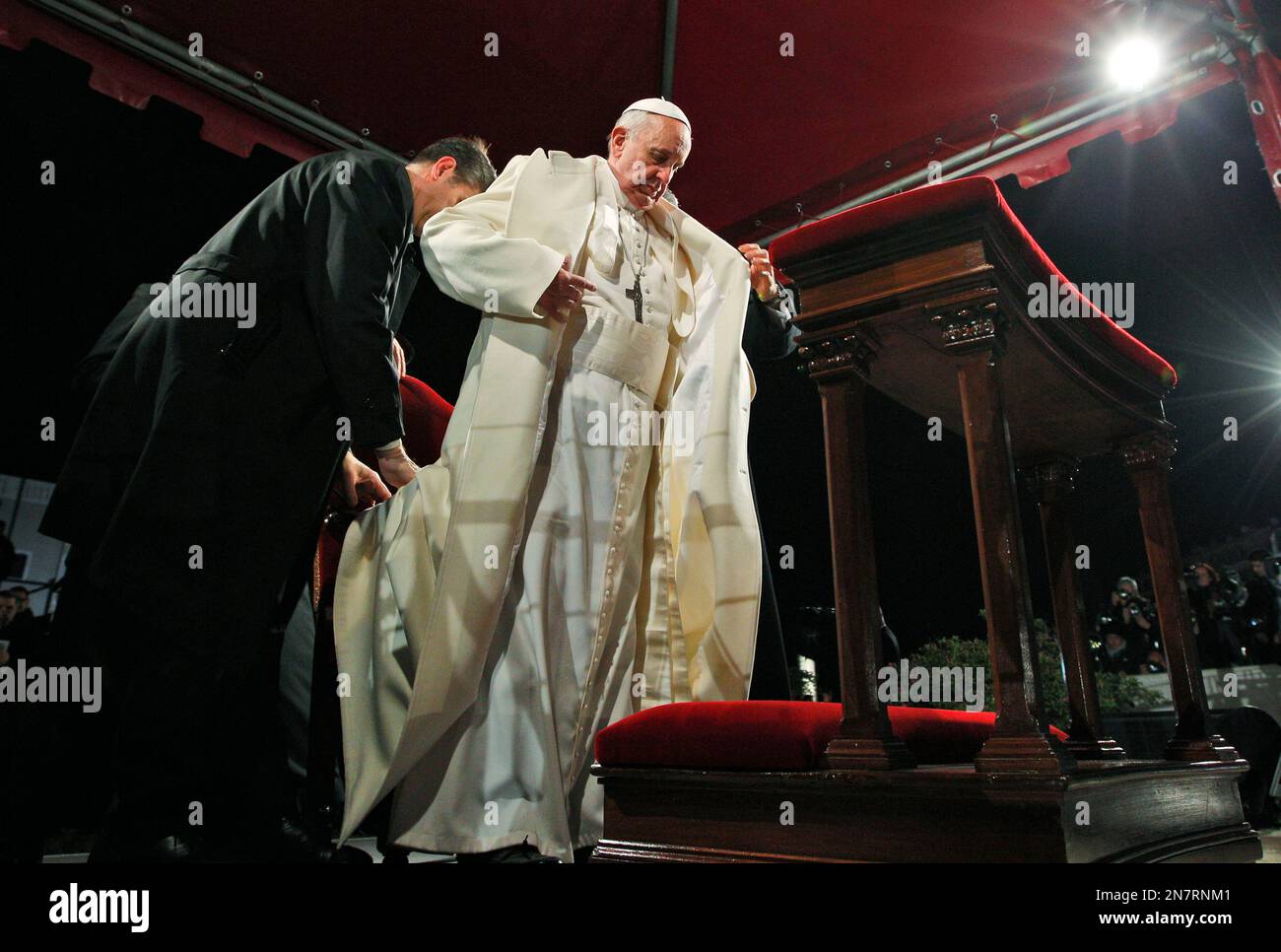 Pope Francis puts his coat on as he prepares to preside the Via Crucis ...
