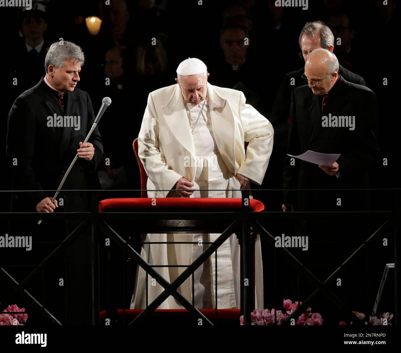 Pope Francis reaches in his pocket for his spectacles as he leads the ...