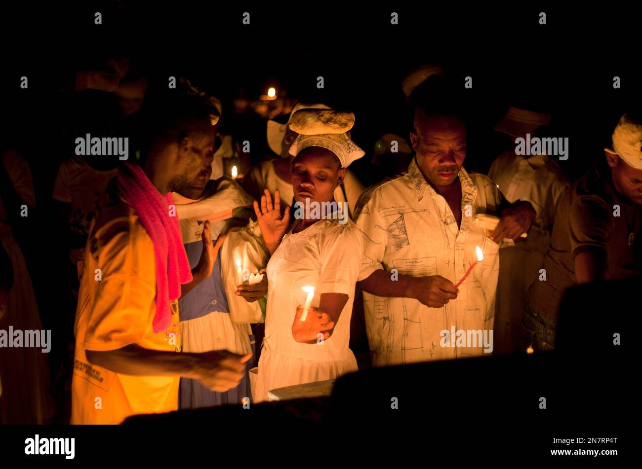 Haitians light candles at the start of their pilgrimage to Calvaire ...