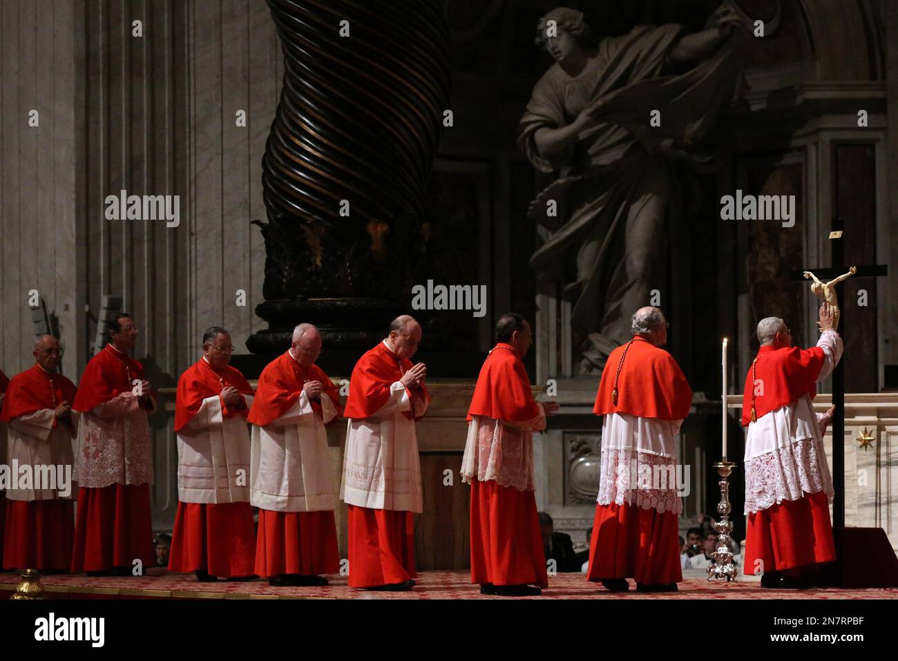 Cardinals line up to touch the Crucifix during the Passion of Christ ...