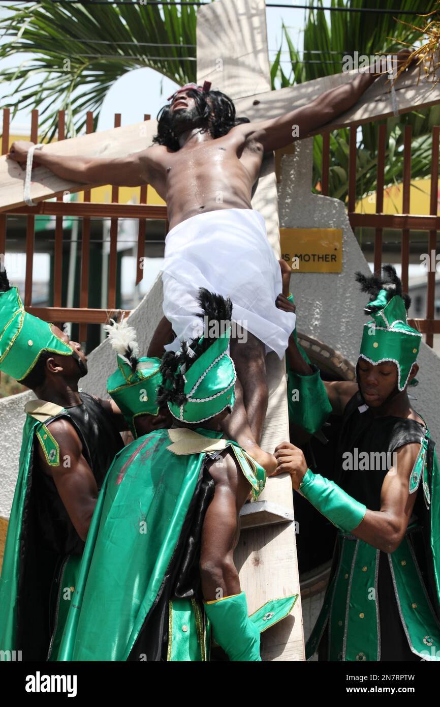 A man dressed as Jesus Christ is lifted up after being secured on a ...