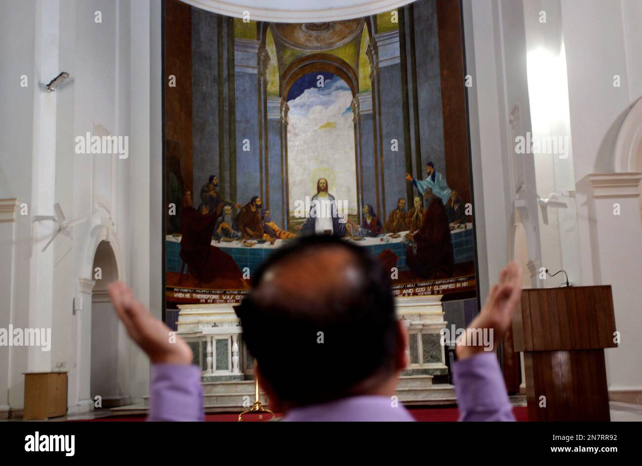 An Indian Christian devotee prays in a church on Good Friday in New ...