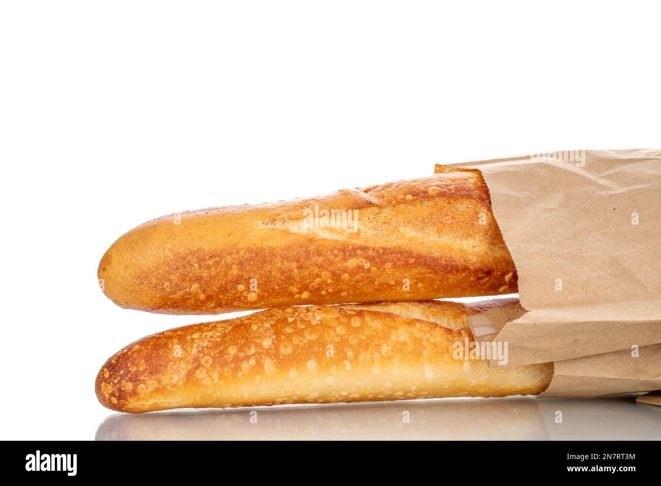 Two aromatic baguettes in a paper bag, macro isolated on white ...