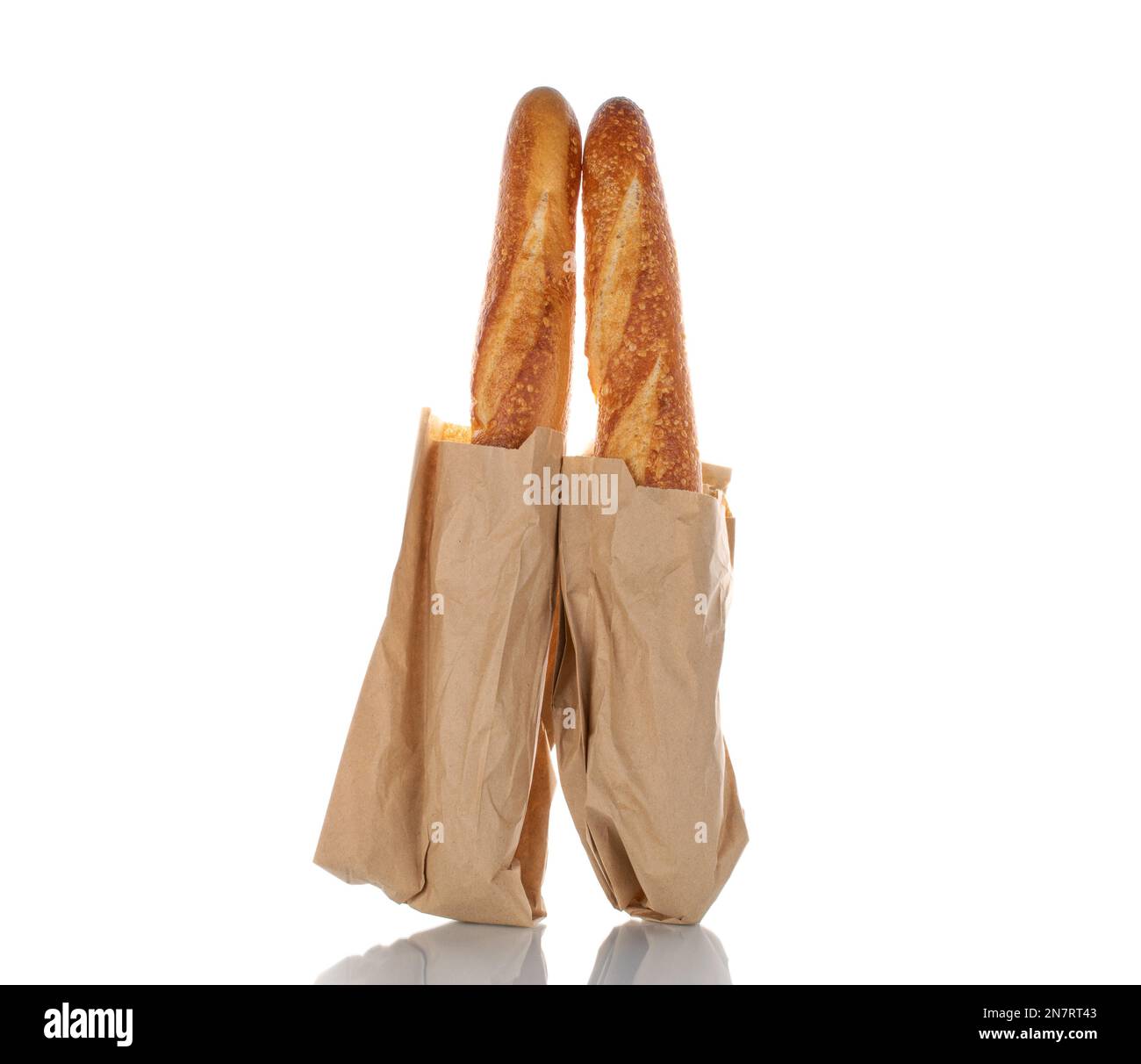 Two aromatic baguettes in a paper bag, macro isolated on white ...