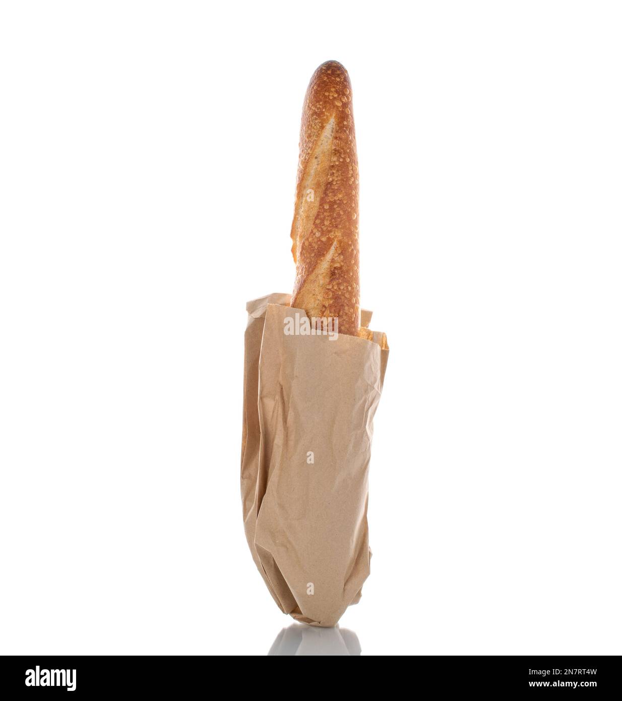 One aromatic baguette in a paper bag, macro isolated on white ...