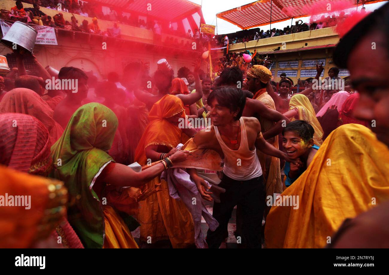 Indian Hindu women tear apart clothes of men on the occasion of Holi ...