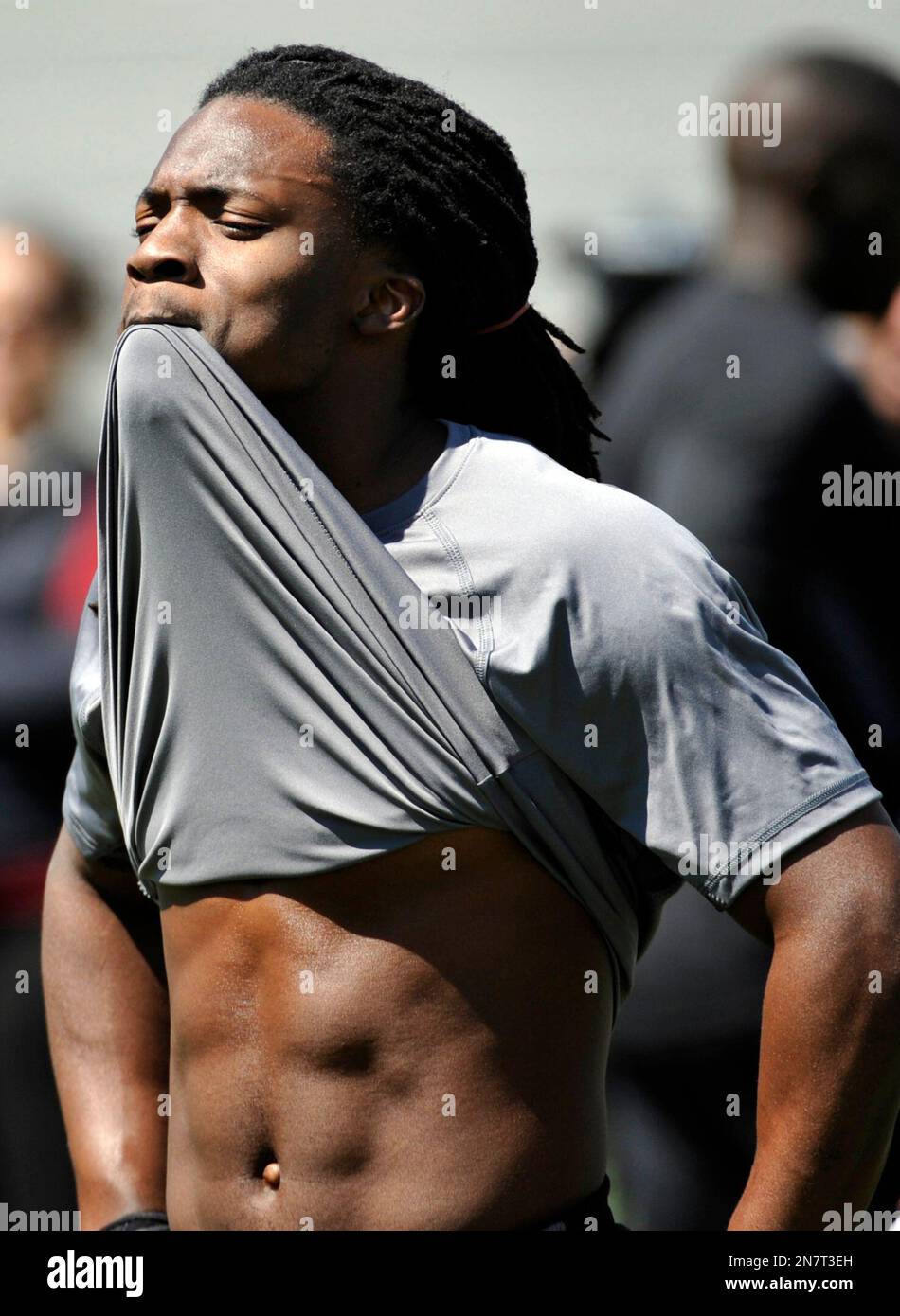 Wide receiver Ace Thomas bites his shirt as he looks on during South ...