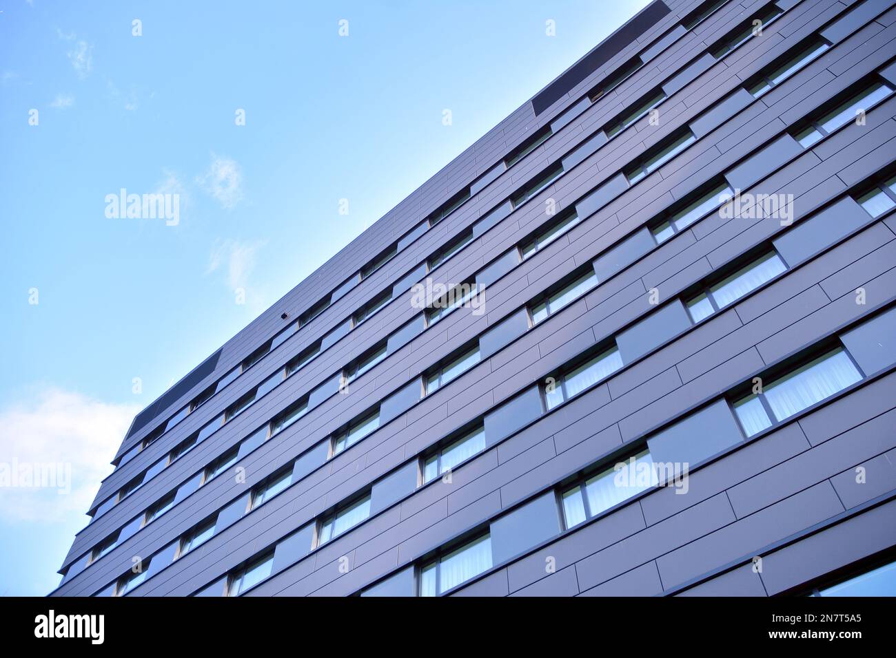 Wall of a modern commercial building with aluminum metal composite ...