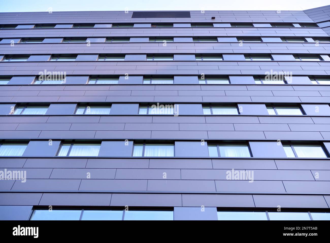 Wall of a modern commercial building with aluminum metal composite ...