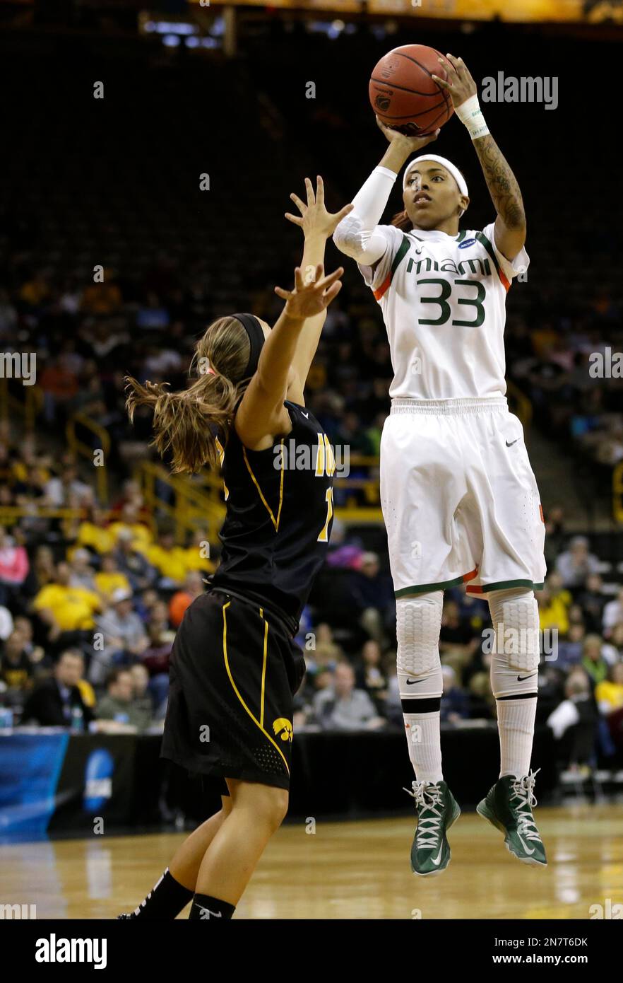 Miami guard Suriya McGuire, right, shoots over Iowa guard Trisha ...