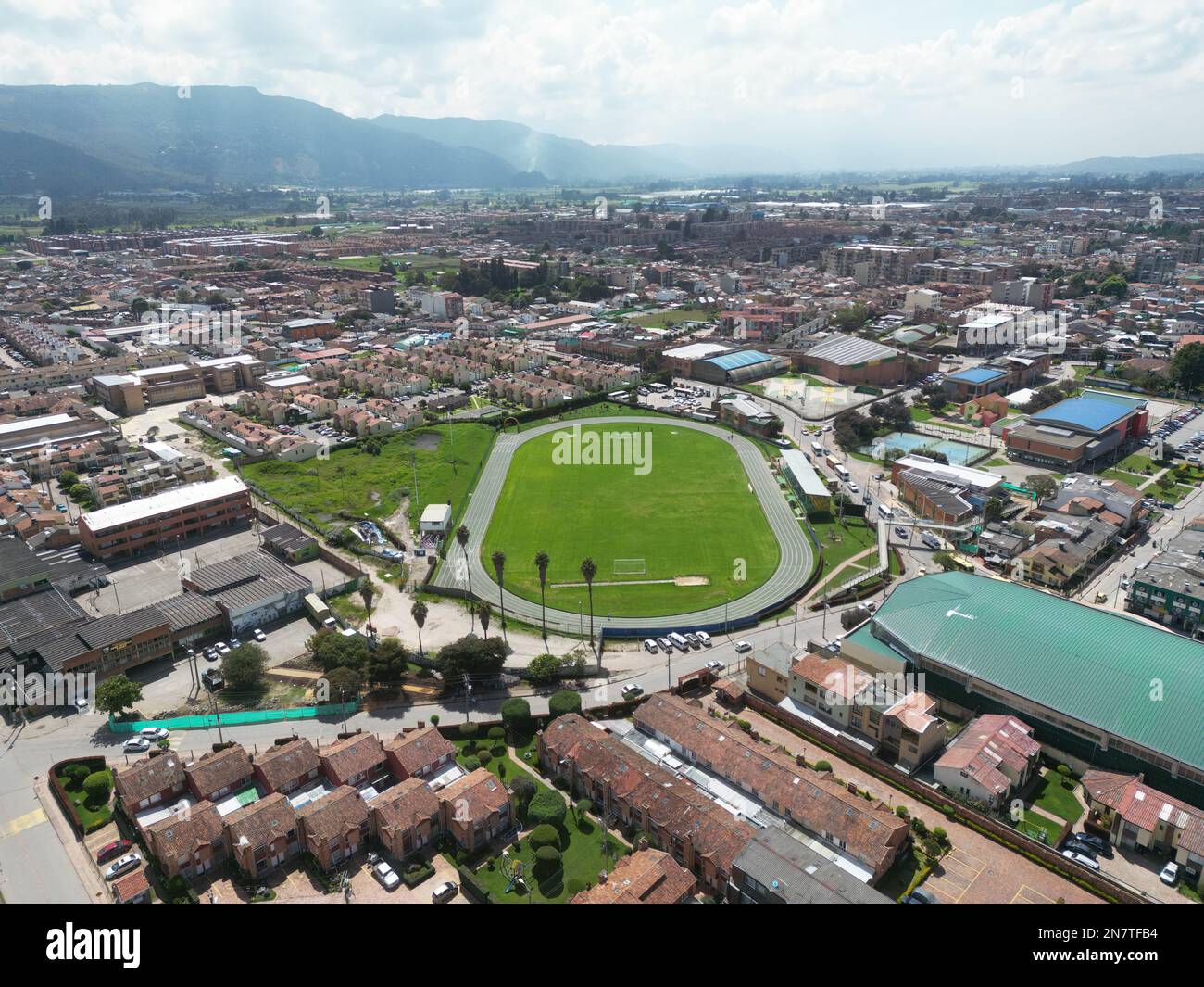 An aerial shot of the urban town of Chia and its soccer field in ...