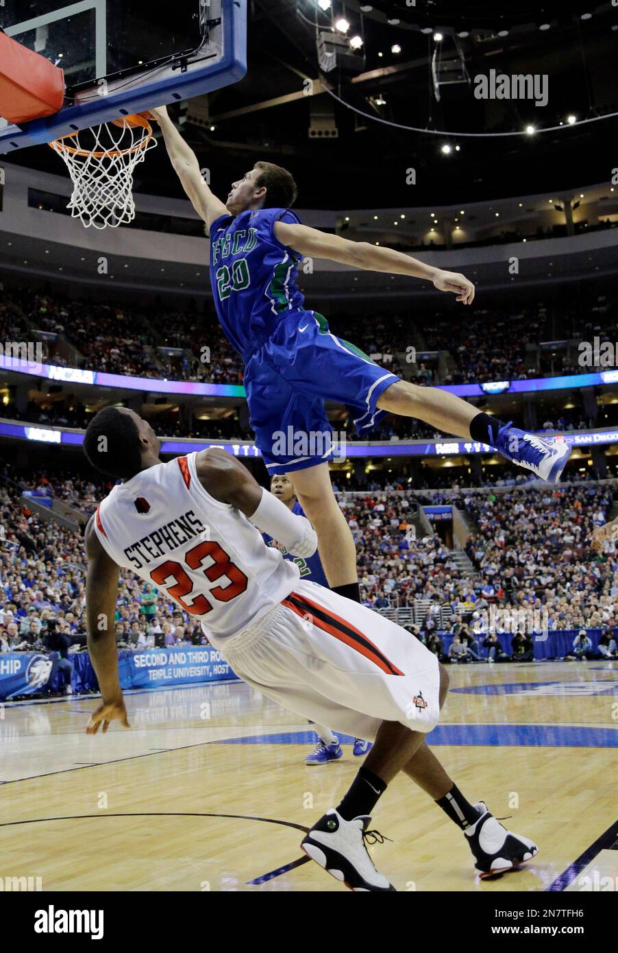 Florida Gulf Coast's Chase Fieler, top, dunks over San Diego State's ...