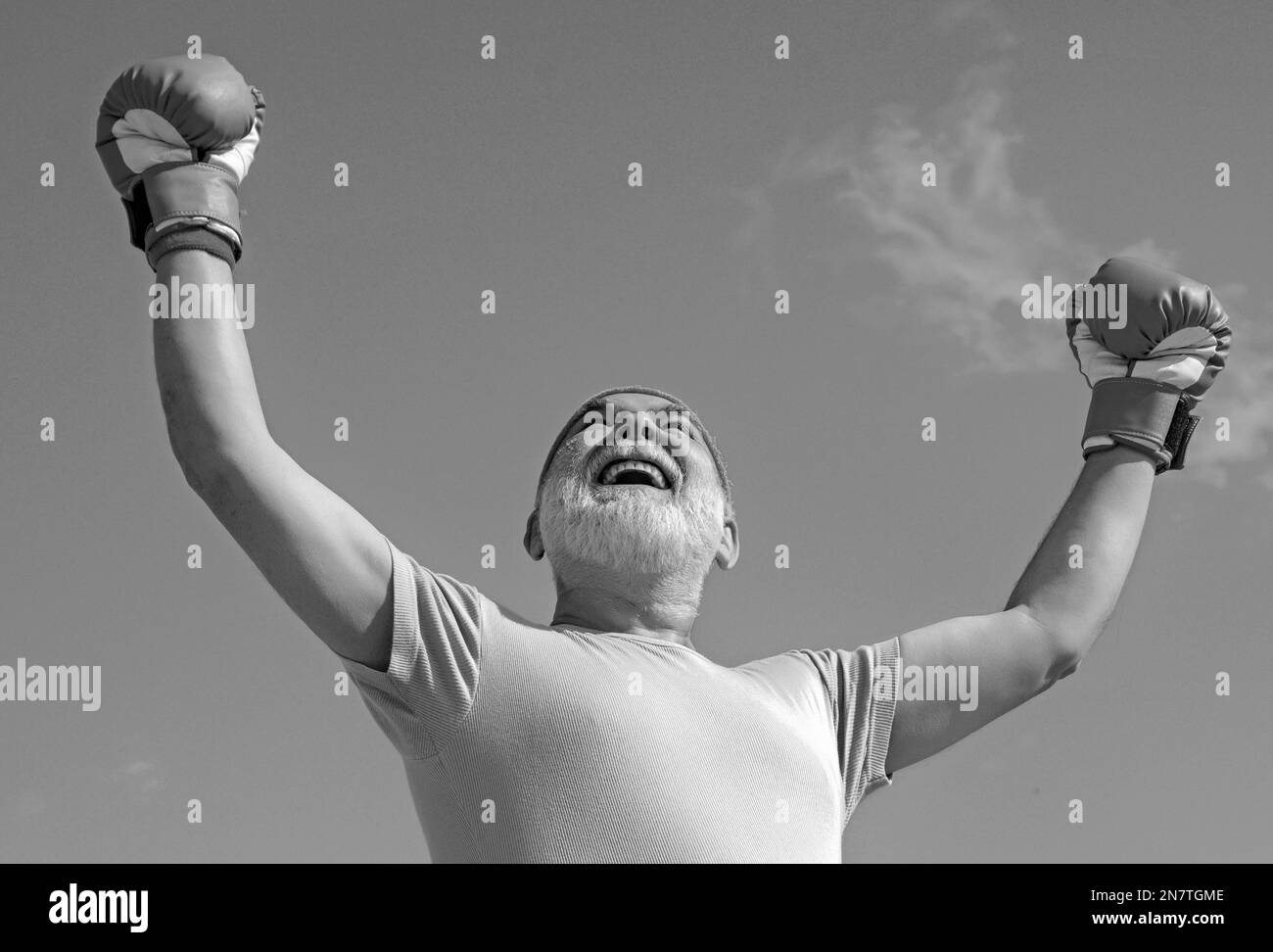Happy Senior sportive man in boxing stance doing exercises with boxing ...