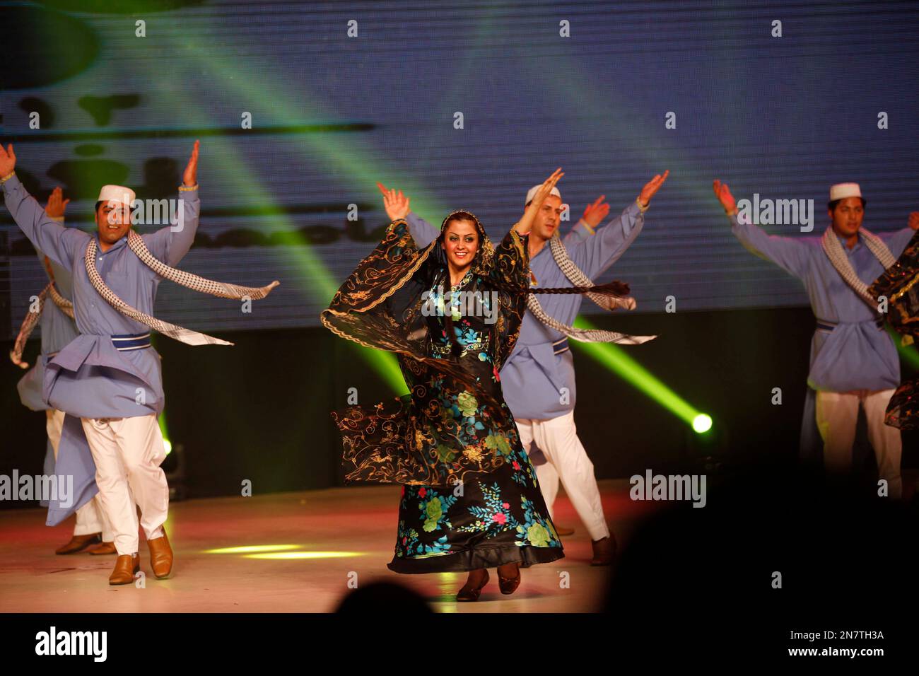Dancers wearing traditional Iraqi folk costumes perform during a ...