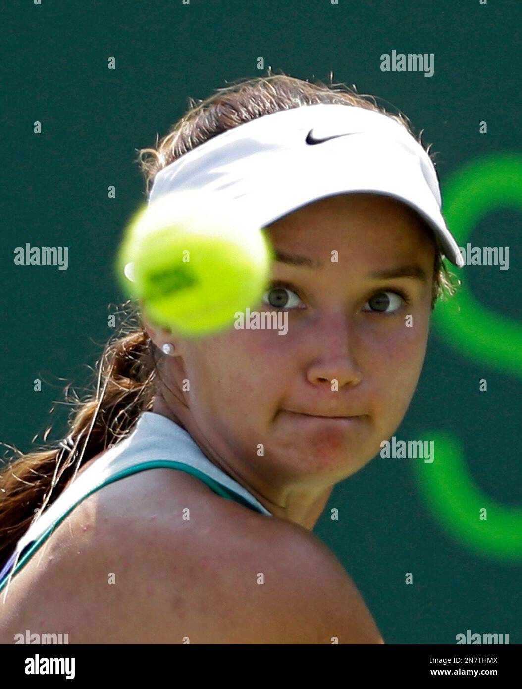 Lauren Davis, of the United States, keeps her eyes on the ball as she ...